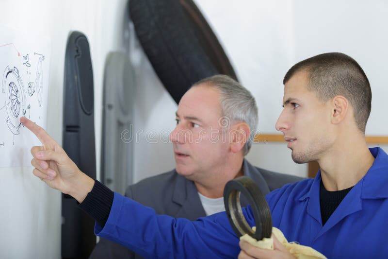 Student with Auto Part and Teacher in Automotive School Stock Image ...