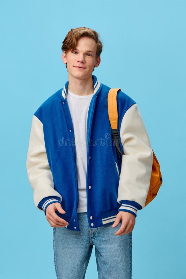 Student with a Backpack on His Shoulder Posing on a Blue Background ...