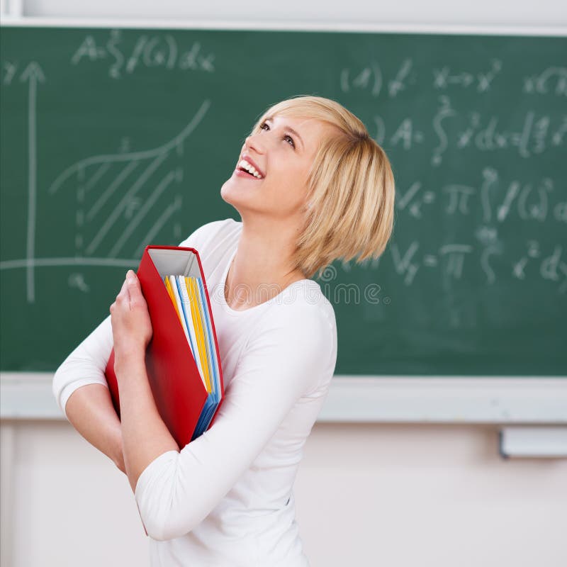 Student with Binder Looking Up Against Chalkboard Stock Photo - Image ...