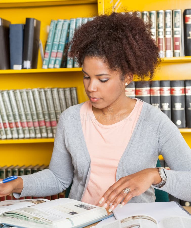 Student with Books Studying at Table in Library Stock Image - Image of ...