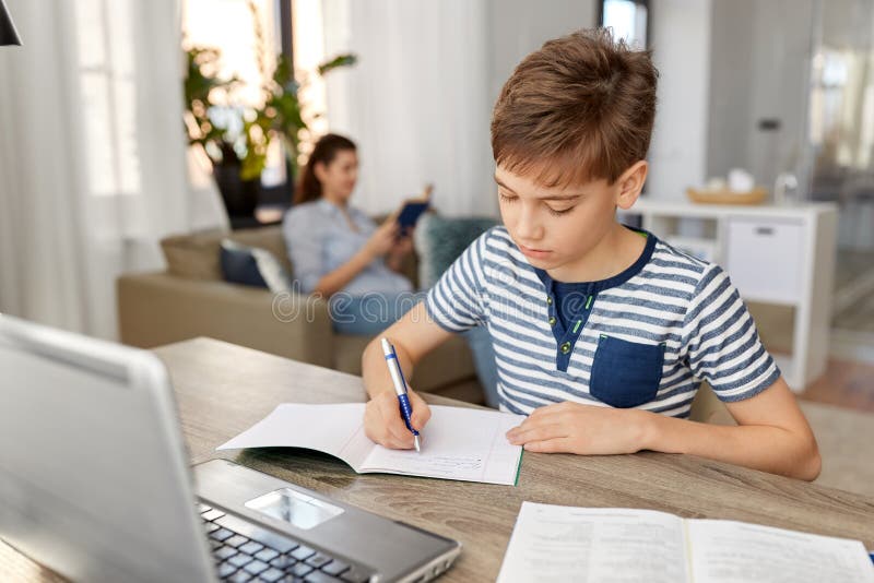 Student Boy with Book Writing To Notebook at Home Stock Photo - Image ...