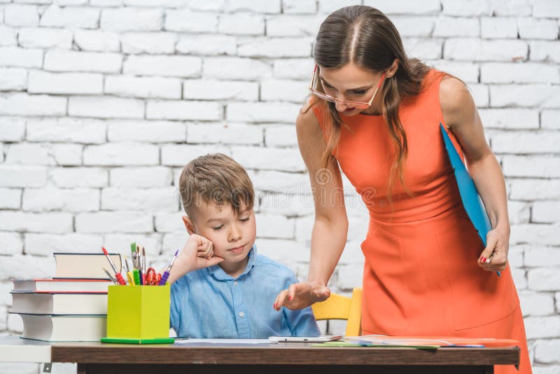 Student Boy Doing Work in School Supervised by His Teacher Stock Photo ...