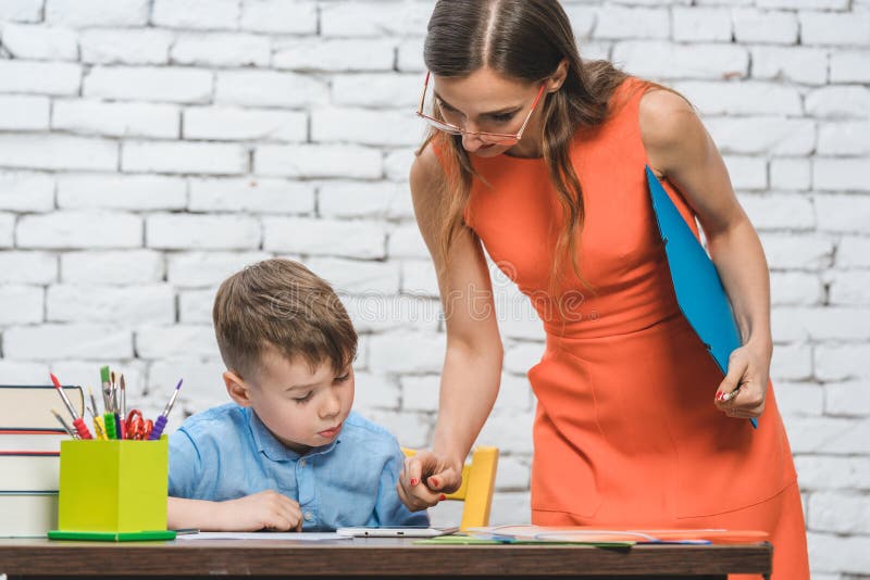 Student Boy Doing Work in School Supervised by His Teacher Stock Image ...