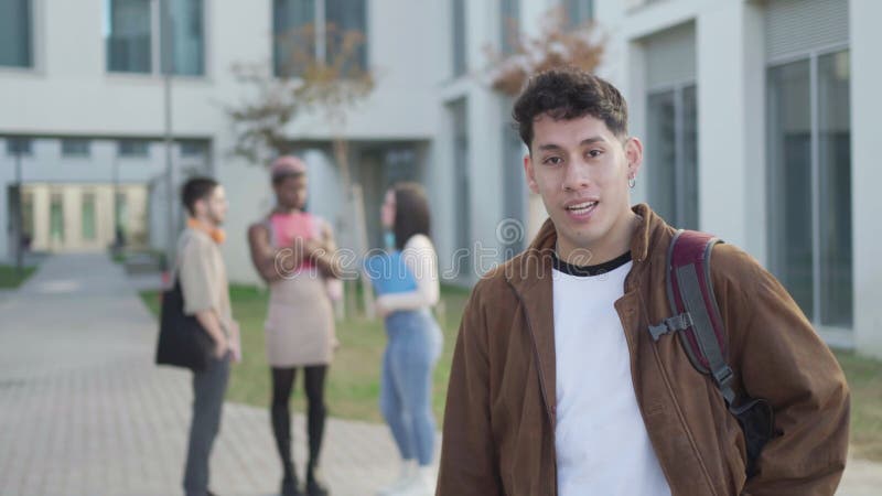 Student Girl Looking at Camera while Her Friends are Behind Talking, in ...