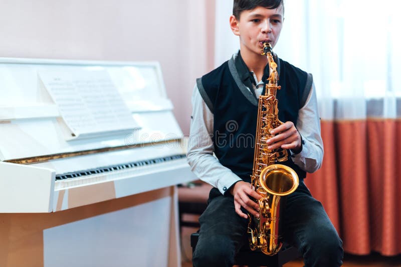 Cheerful Student Boy Sitting with Saxophone before Music Lesson Stock ...