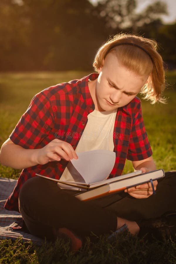 Student Boy Study Up in Green Park Alone, Study Outdoors in University ...