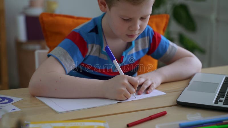 A Little Elementary School Girl Sits on a Parapet in the Background of ...