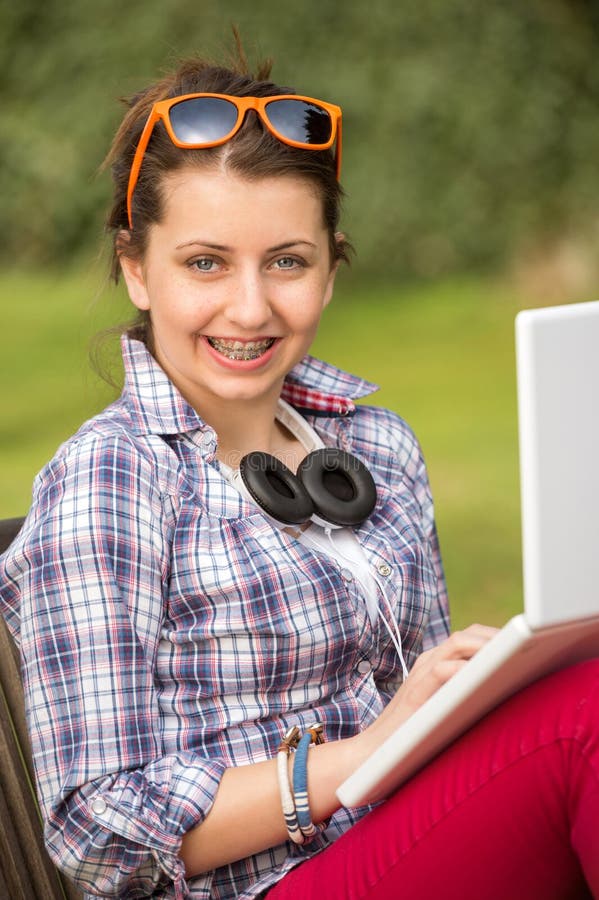 Student with Braces Using Laptop at Park Stock Photo - Image of ...