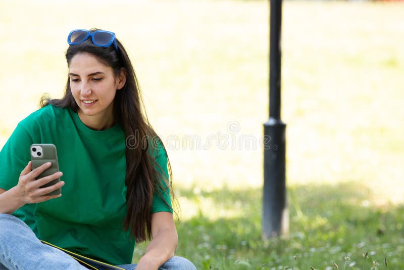 Student on Campus Looking at Mobile Phone Stock Photo - Image of online ...