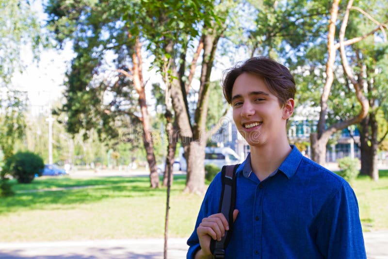 Student Carrying Backpack on One Shoulder and Smiling. Outside Portrait ...