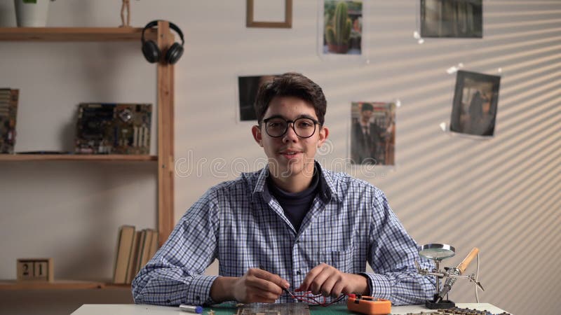 Student Checking Circuit Board with Multimeter on the Table at Home and ...