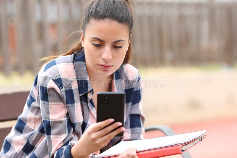 Student Checking Phone in a Park Stock Photo - Image of reading, woman ...