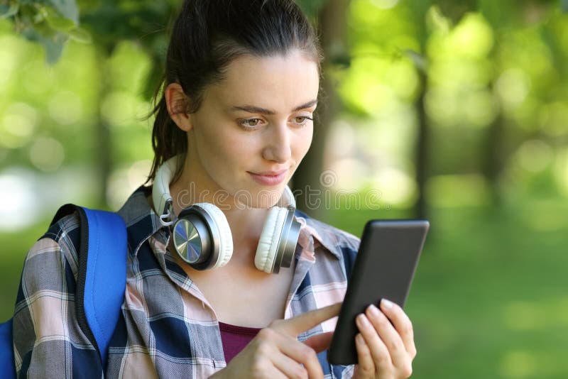 Student Checking Phone Walking in a Green Park or Campus Stock Photo ...