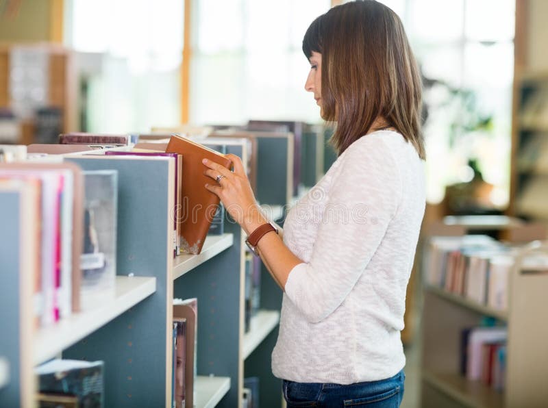 Student Choosing Book in Bookstore Stock Image - Image of building ...