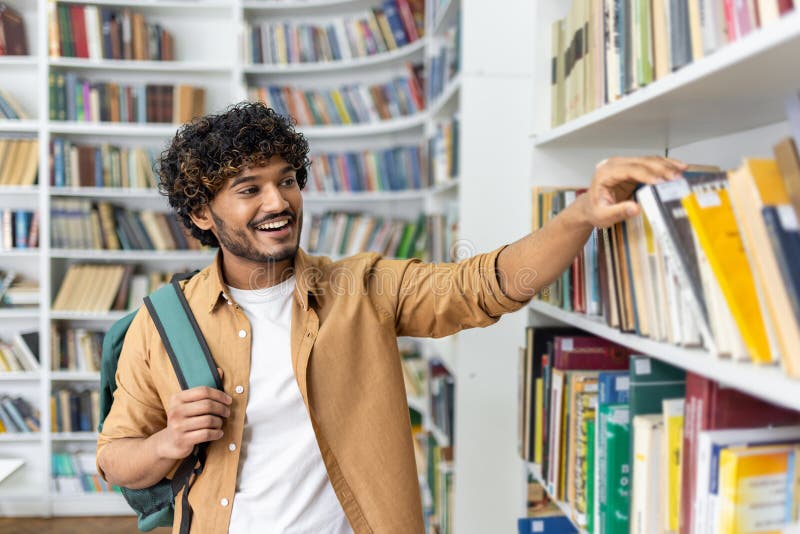 Student Choosing Book from Library Shelf for Education and Learning ...