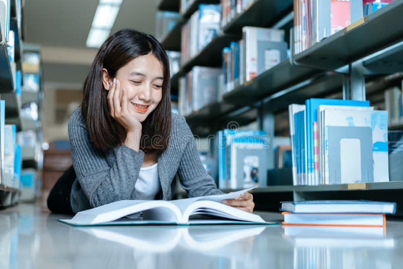 Student College Opening and Reading a Book at Library Stock Photo ...