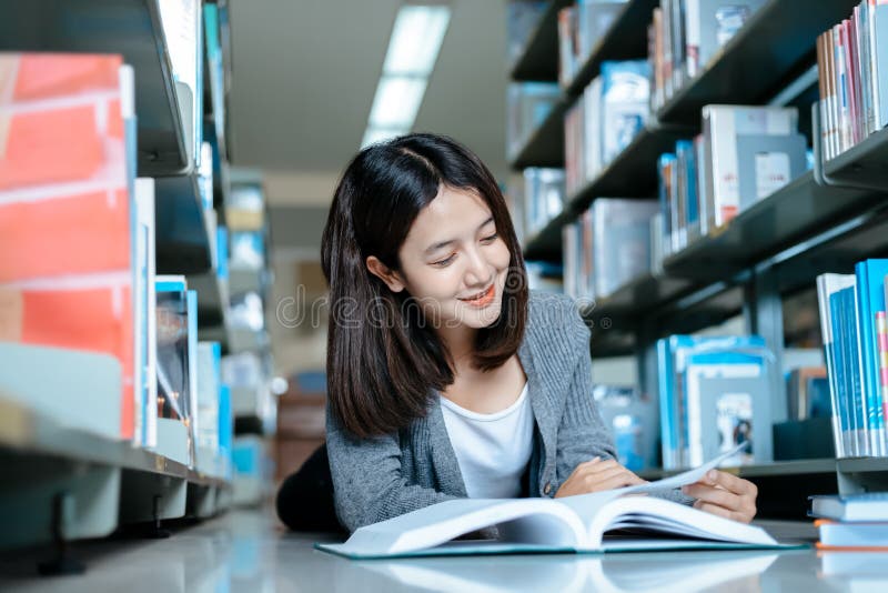 Student College Opening and Reading a Book at Library Stock Photo ...
