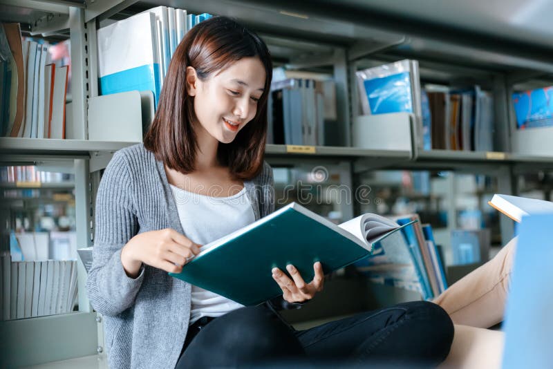 Student College Opening and Reading a Book at Library Stock Photo ...