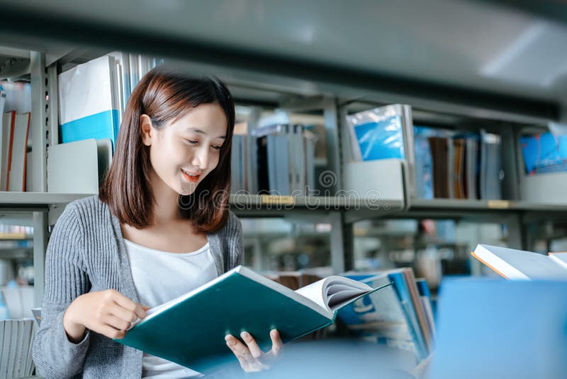 Student College Opening and Reading a Book at Library Stock Photo ...