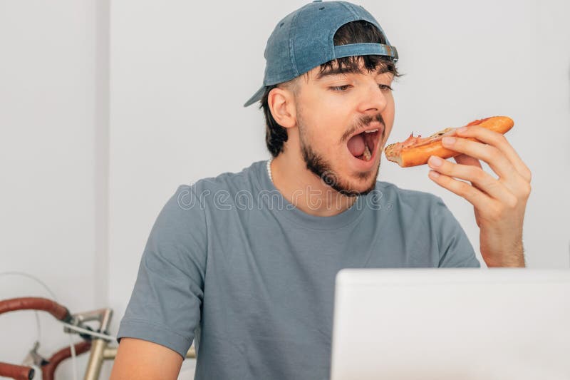 Student with Computer at Desk Eating Pizza Stock Photo - Image of ...