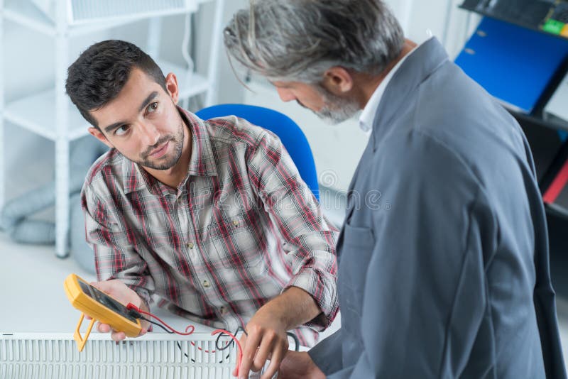 Student in Computing Class Fixing Hardware with Teacher Stock Photo ...
