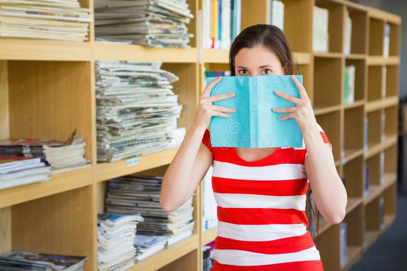 Student Covering Face with Book in Library Stock Photo - Image of ...