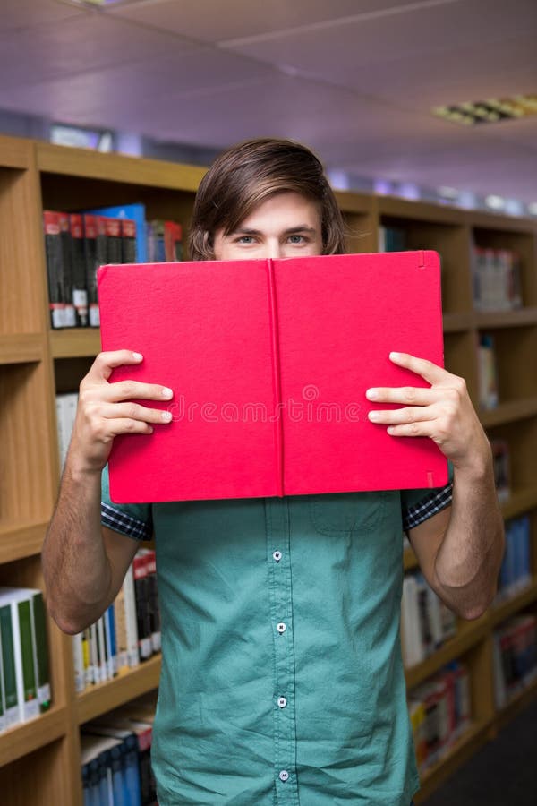 Student Covering Face with Book in Library Stock Image - Image of ...