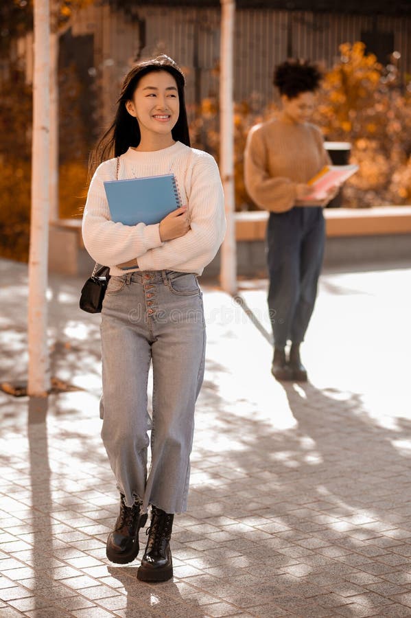 A Cute Long-haired Asian Girl with a Book Stock Image - Image of ...