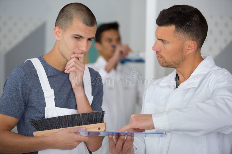 Student Decorator Holding Wallpapering Brush Talking To Supervisor ...