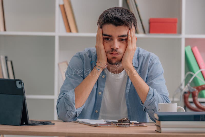 Young Man at Desk Studying Overwhelmed Stock Image - Image of ...