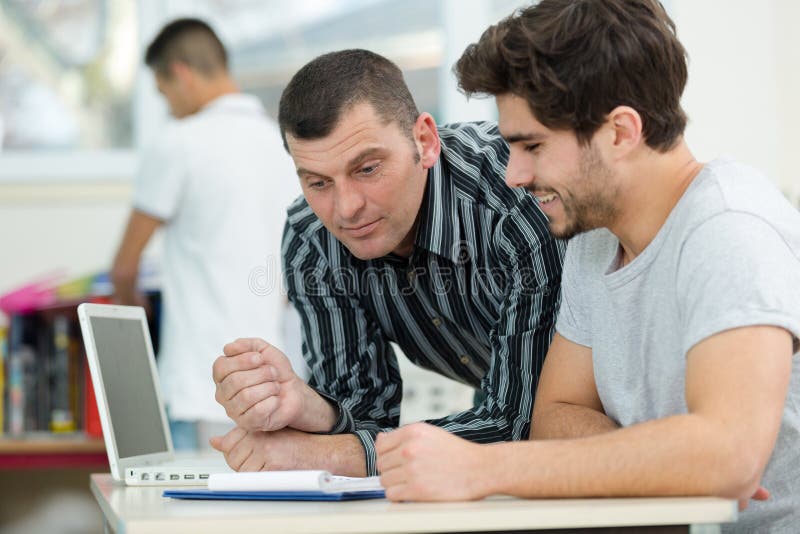 Student Discussing with Teacher in Classroom Stock Photo - Image of ...