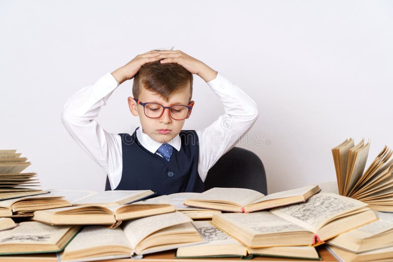 The Student Does His Homework, Holds His Head with His Hands and Looks ...