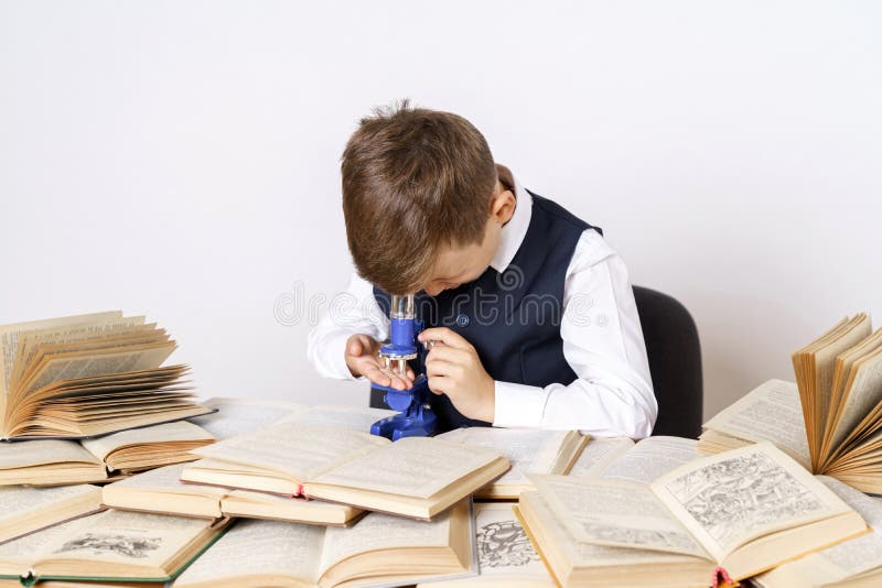 A Student Does Homework, Looks through a Microscope. There are Many ...