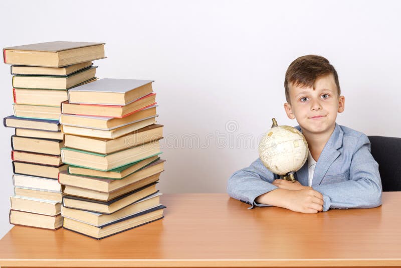 The Student Does Homework, Studies the Globe. he Has Books on Both ...