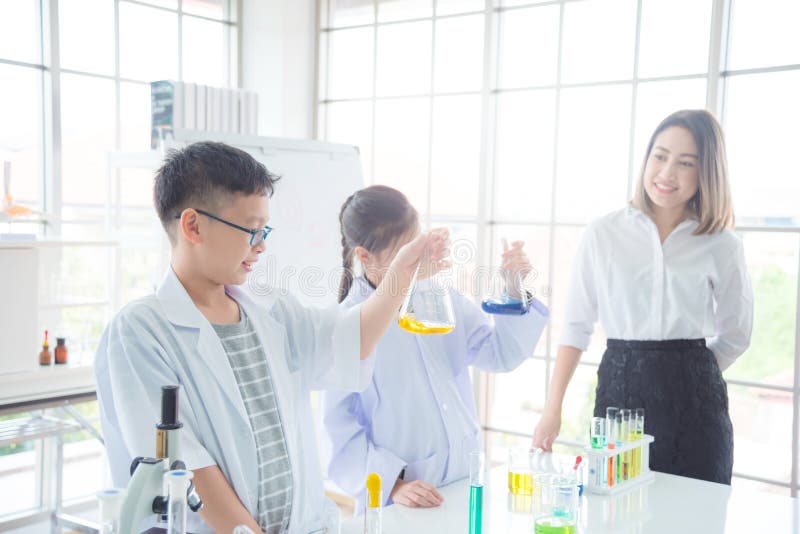 In Chemistry Classroom with Many Laboratory Tools. Two Little Asian ...
