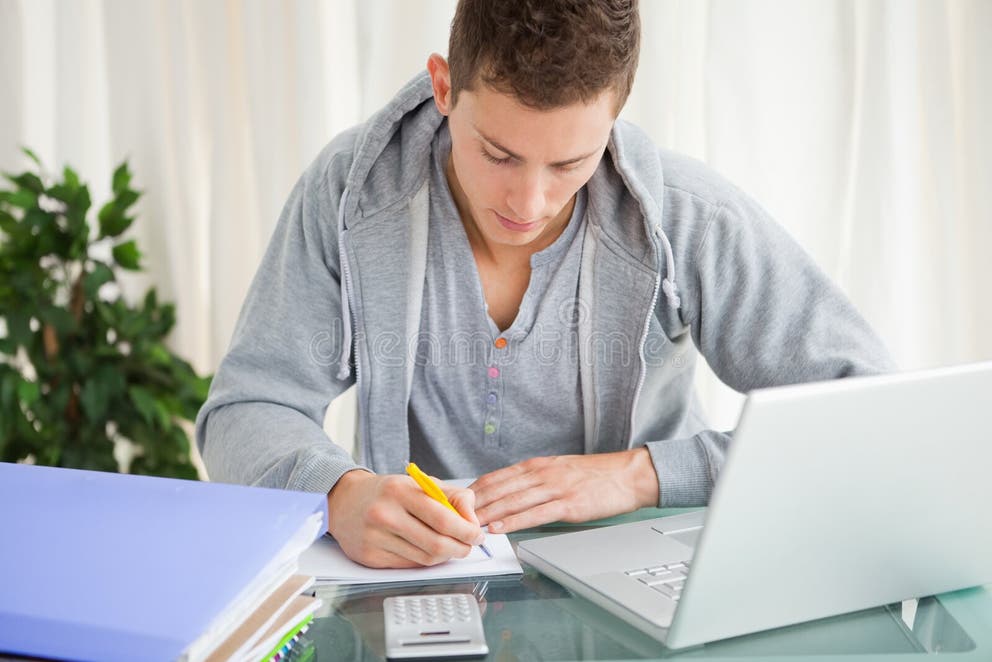 Student doing his homework stock image. Image of home - 25334833