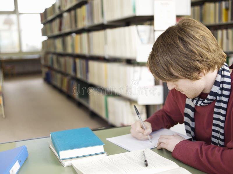 Student Doing Homework in Library Stock Image - Image of book, indoors ...