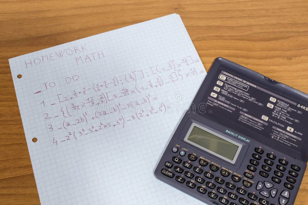 A Student is Doing Math Homework with a Calculator on a Wood Tab Stock ...