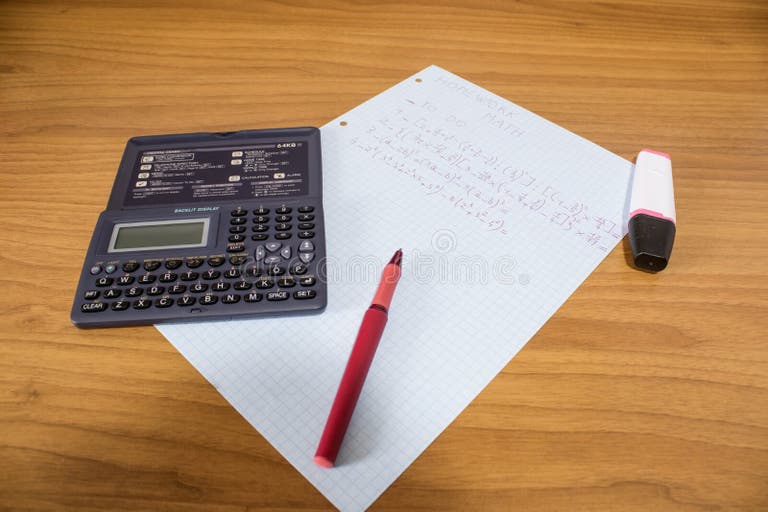 A Student is Doing Math Homework with a Calculator on a Wood Tab Stock ...