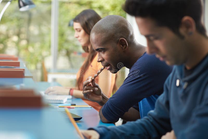 Student Eating Chocolate Bar in Library Stock Image - Image of desk ...