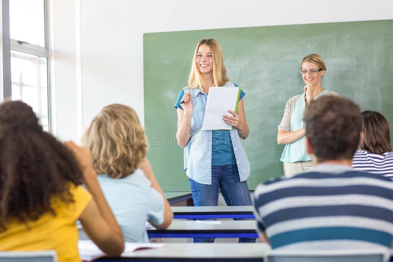 Student Explaining Notes Besides Teacher in Class Stock Image - Image ...