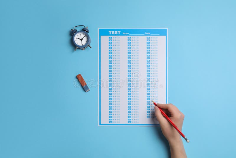 Student Filling Answer Sheet on Yellow Background, Top View with Space ...