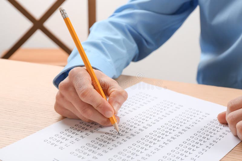 Student Filling Answer Sheet at Table Stock Photo - Image of choice ...
