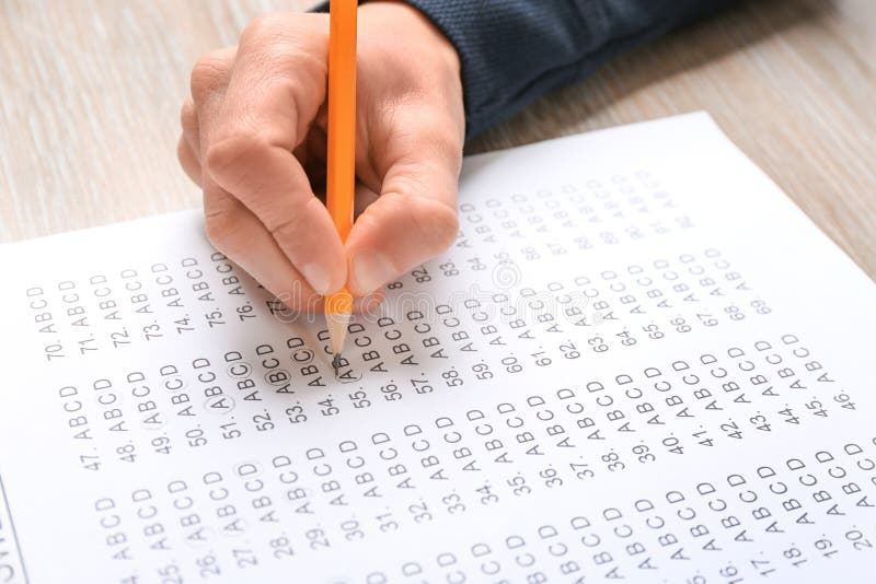 Student Filling Answer Sheet at Table Stock Image - Image of college ...