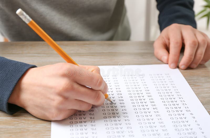Student Filling Answer Sheet at Table Stock Image - Image of learning ...