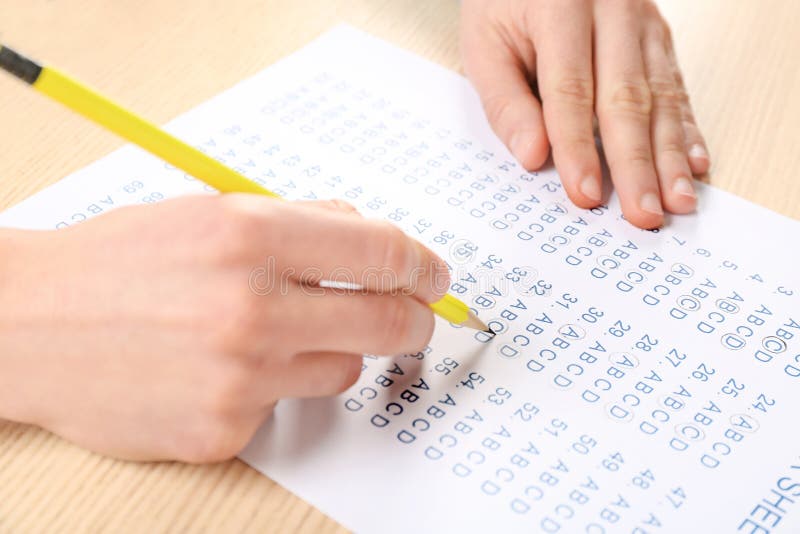 Student Filling Answer Sheet at Table Stock Image - Image of lesson ...