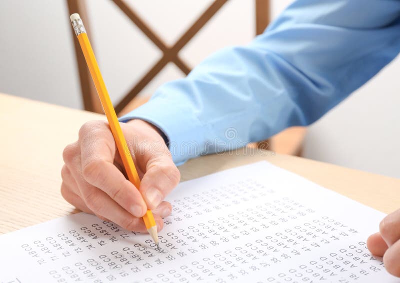 Student Filling Answer Sheet at Table Stock Image - Image of lesson ...