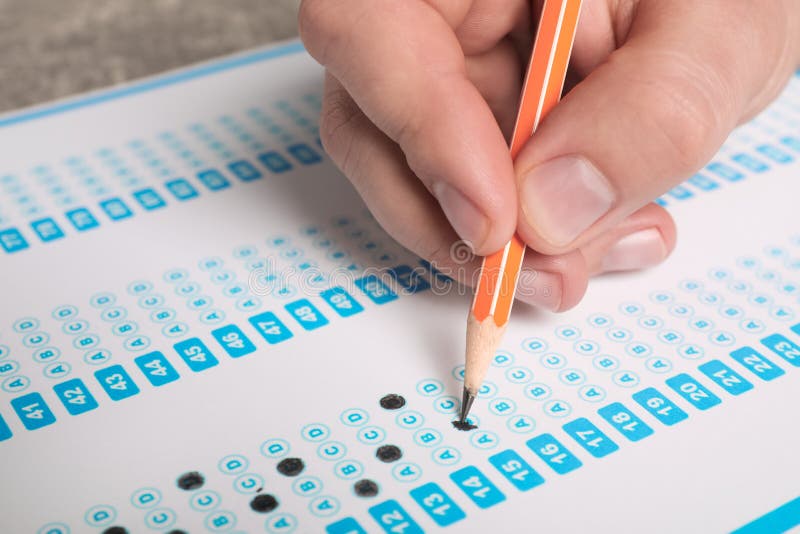Student Filling Answer Sheet at Table, Closeup. Passing Exam Stock ...