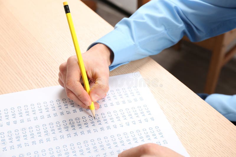 Student Filling Answer Sheet at Table Stock Photo - Image of evaluation ...