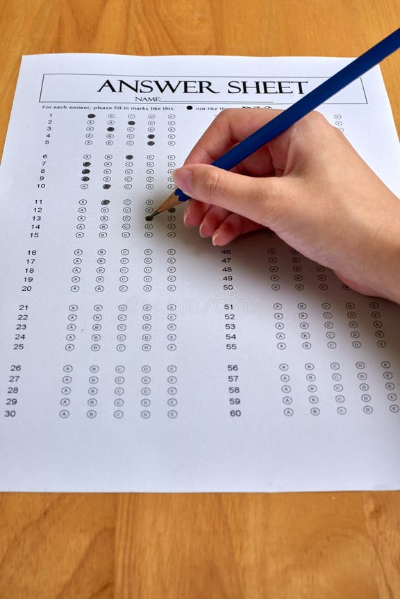 Student Filling Out Answer Sheet during a Test in a Classroom Setting ...
